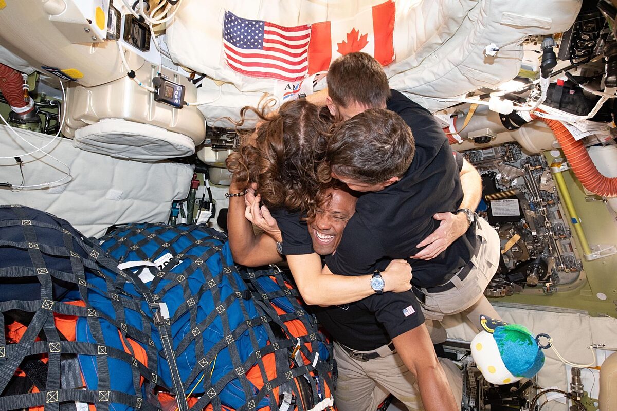 Artemis II crew hug | The Planetary Society